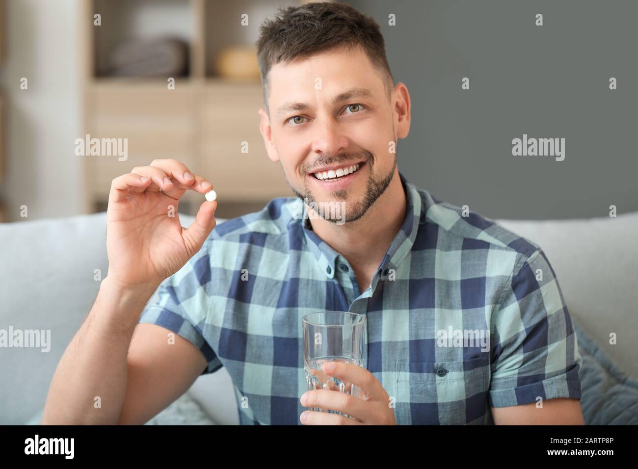 Man taking medicine at home Stock Photo - Alamy