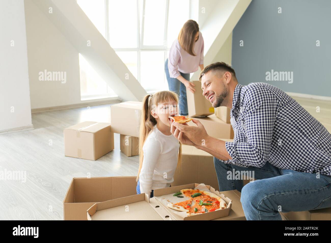 Woman feeding husband pizza hi-res stock photography and images - Alamy