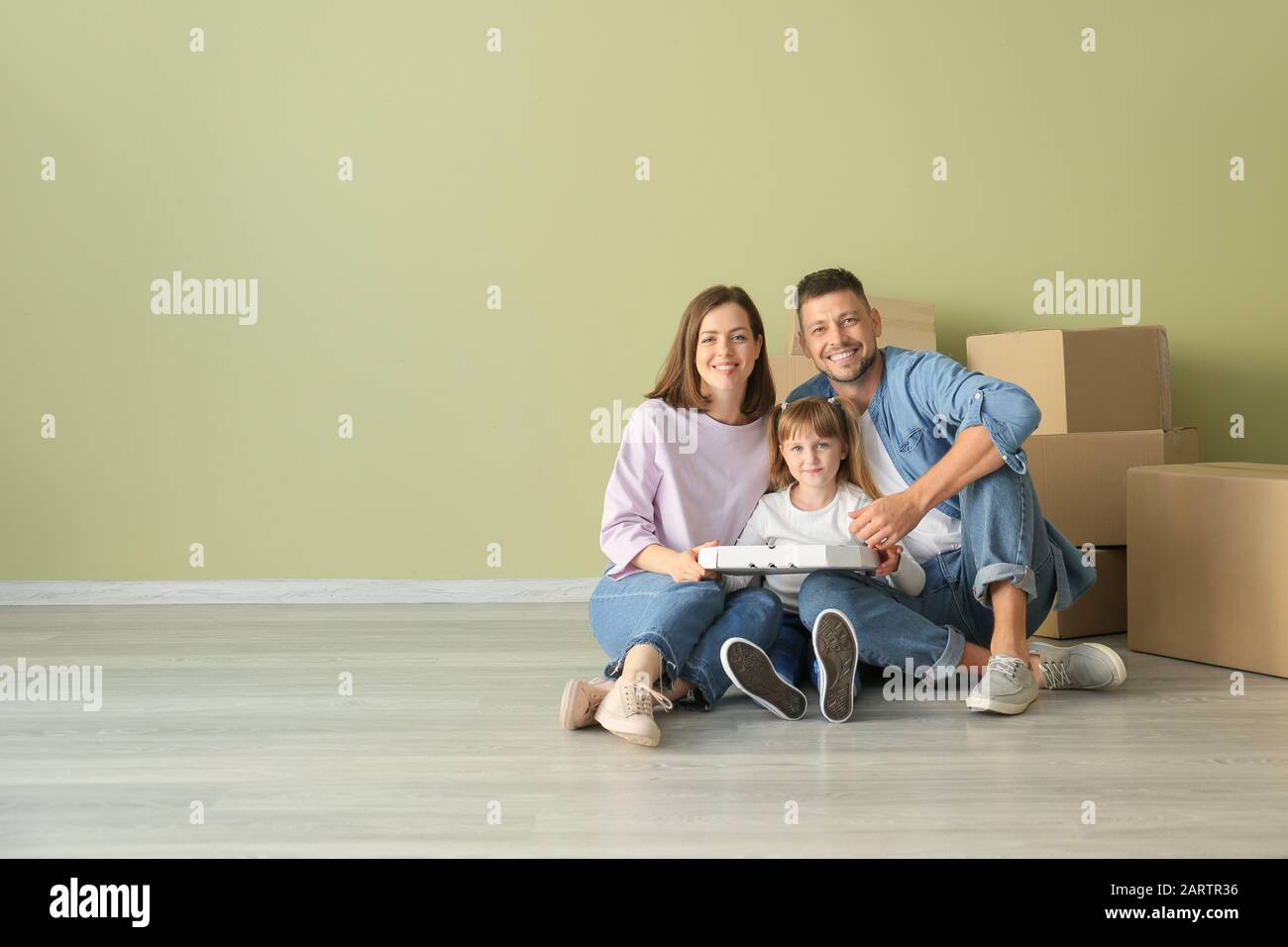 Happy family eating pizza on moving day Stock Photo - Alamy