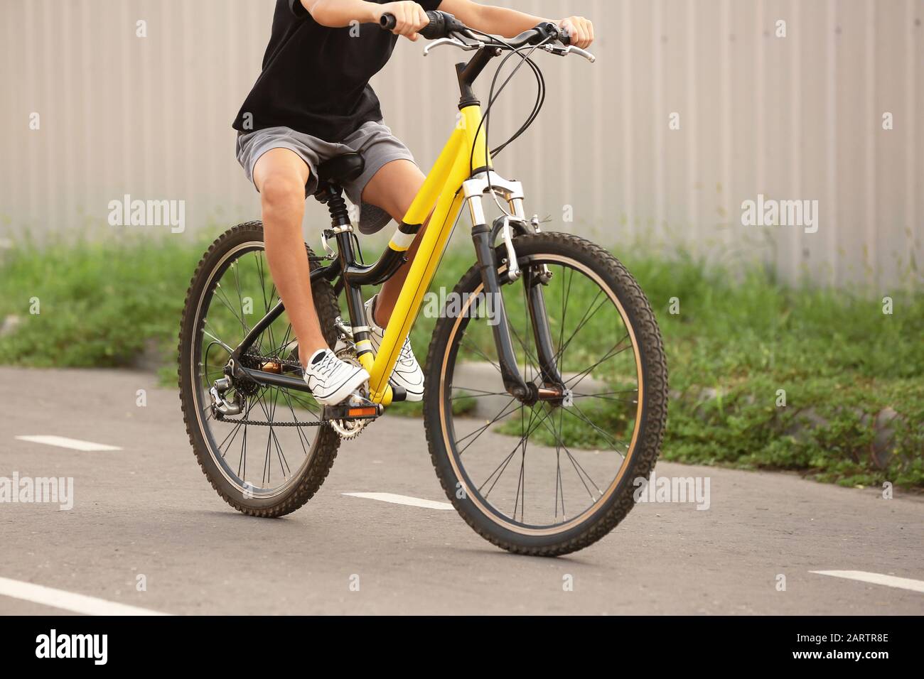 Cute boy riding bicycle outdoors Stock Photo - Alamy