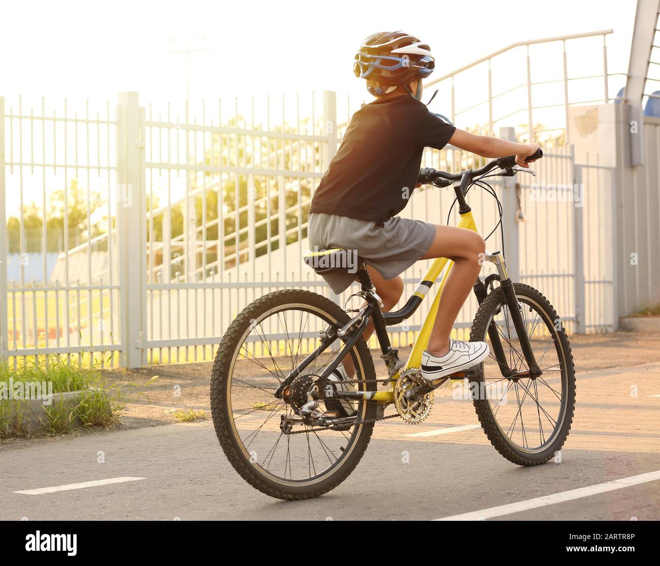 Cute boy riding bicycle outdoors Stock Photo - Alamy