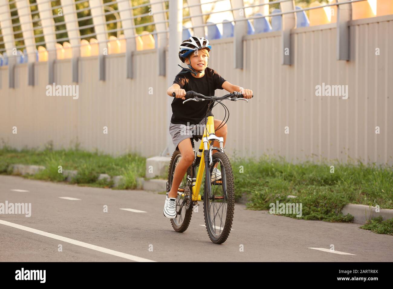 Cute boy riding bicycle outdoors Stock Photo - Alamy