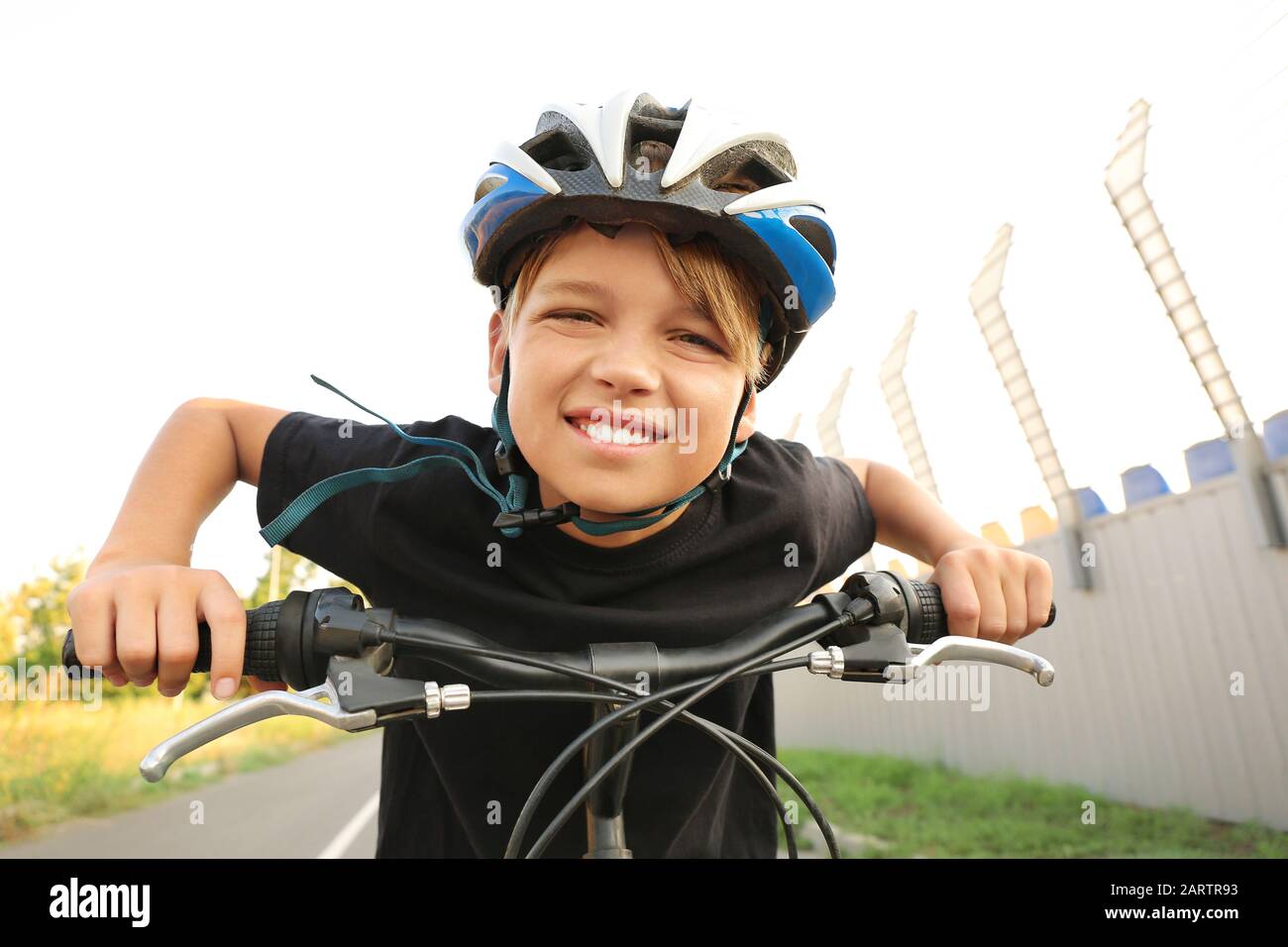 Cute boy riding bicycle outdoors Stock Photo - Alamy