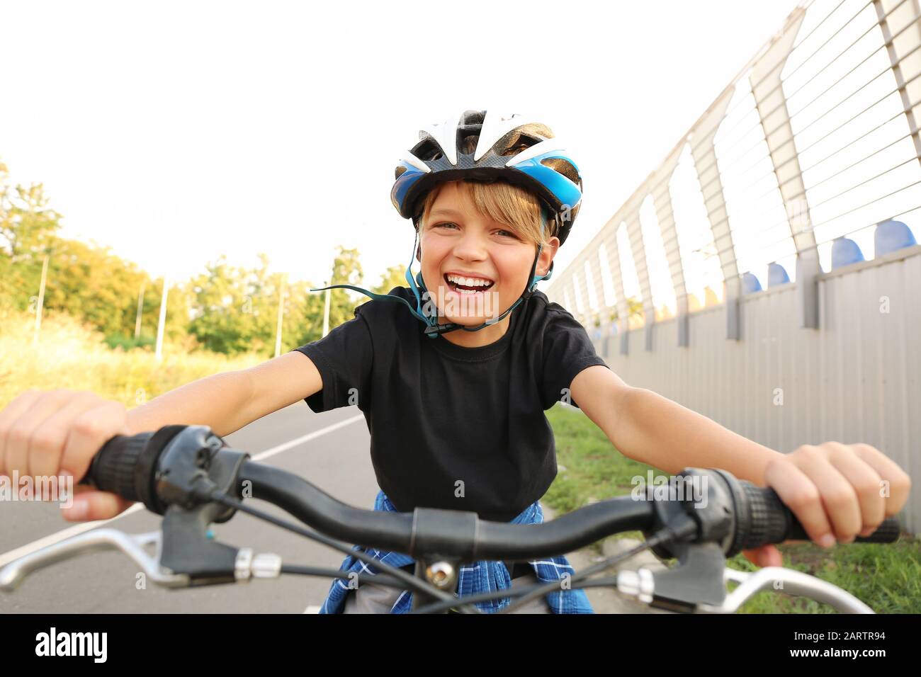 Cute boy riding bicycle outdoors Stock Photo - Alamy
