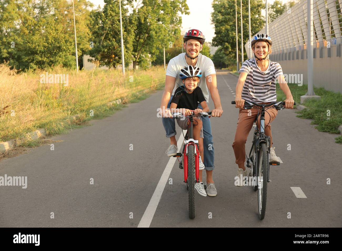 Happy family riding bicycles outdoors Stock Photo - Alamy