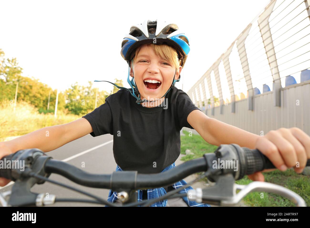 Cute boy riding bicycle outdoors Stock Photo - Alamy