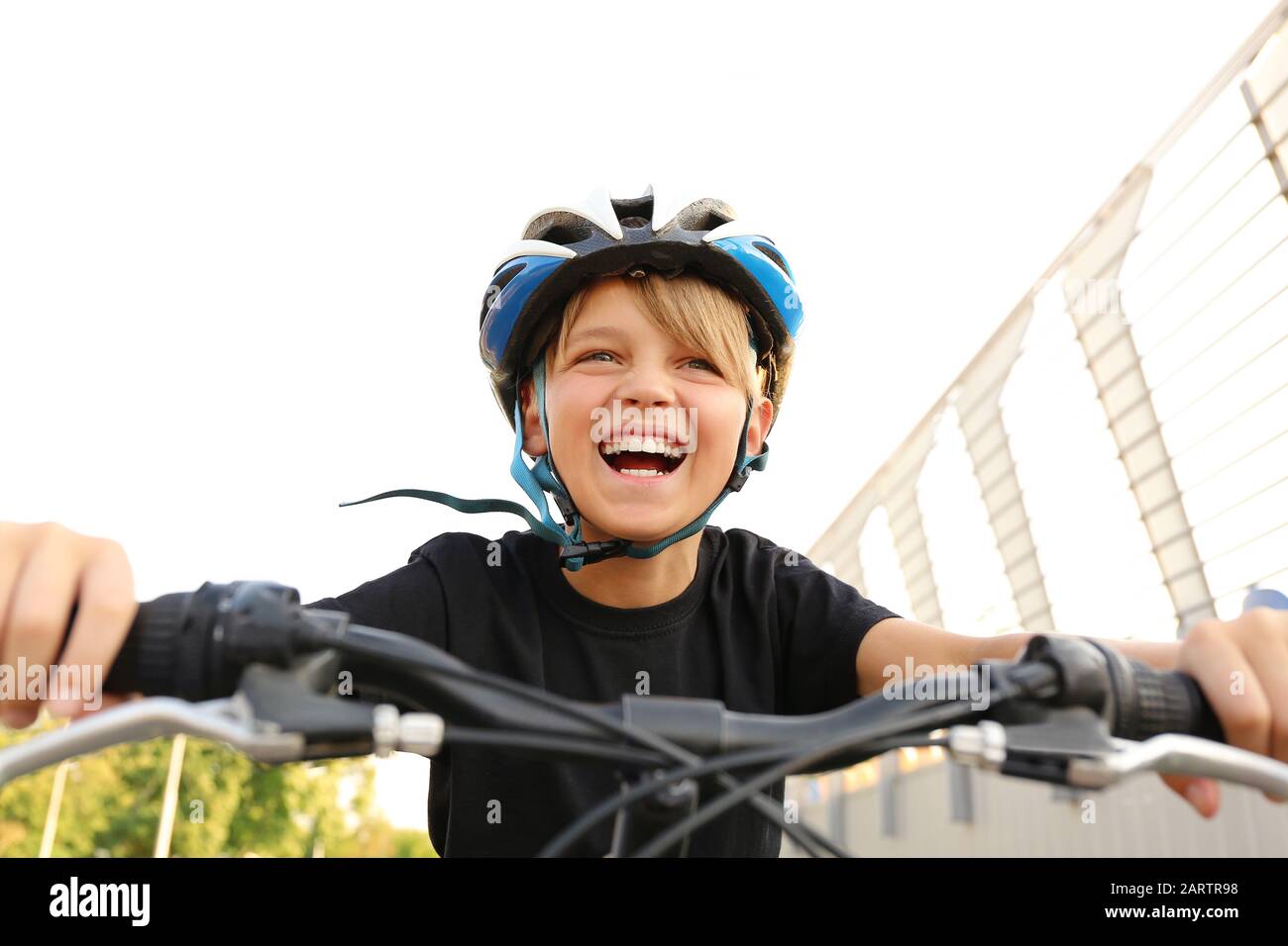 Cute boy riding bicycle outdoors Stock Photo - Alamy