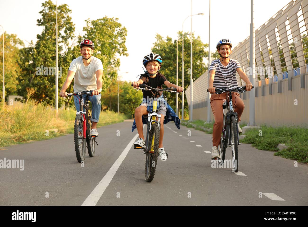 Happy family riding bicycles outdoors Stock Photo - Alamy