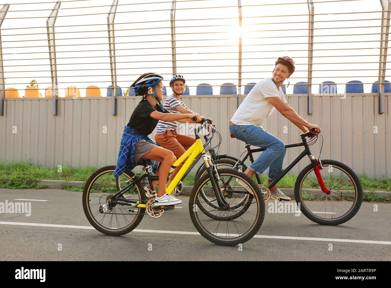 Happy family riding bicycles outdoors Stock Photo - Alamy