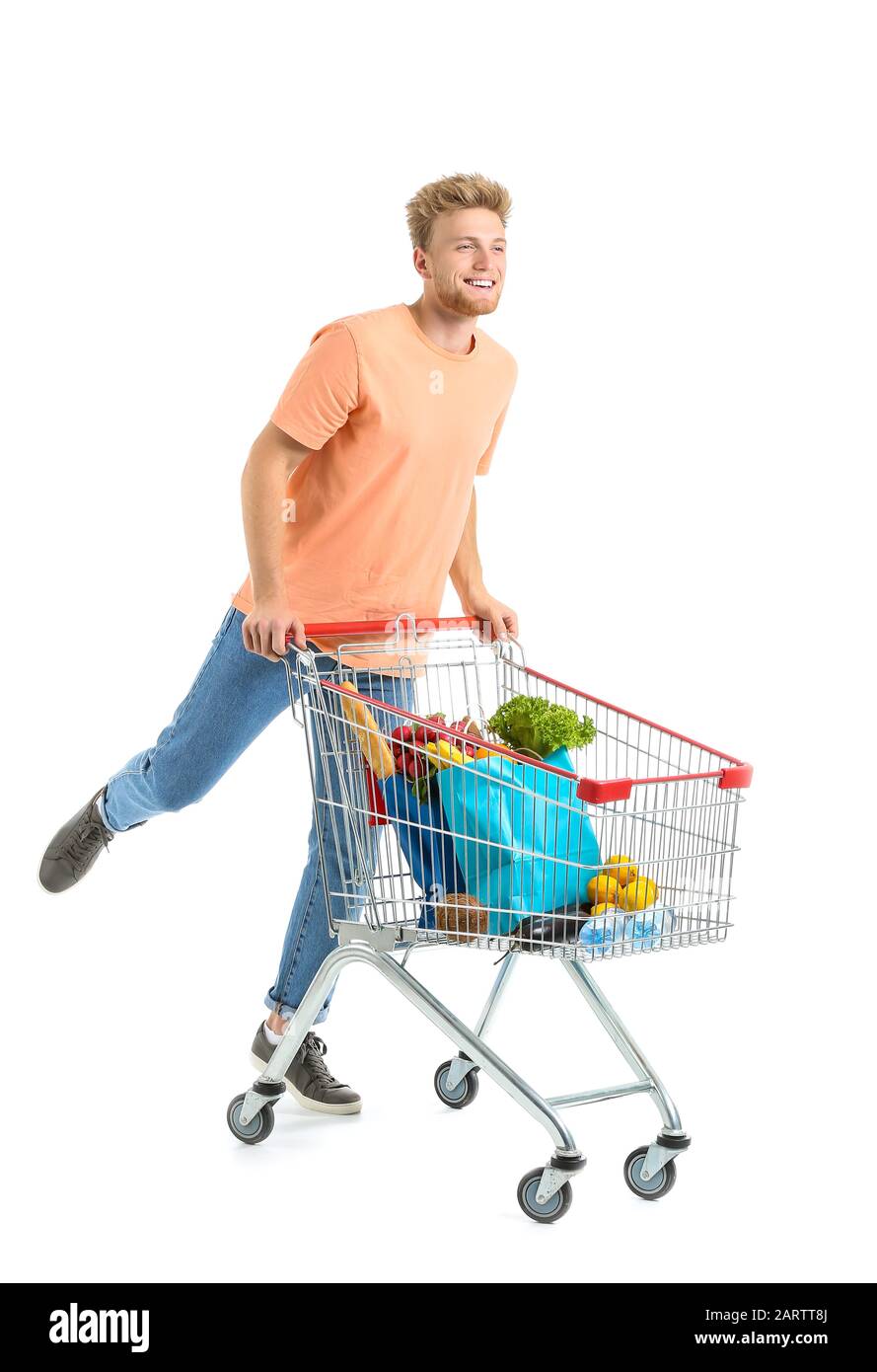 Young man with shopping cart on white background Stock Photo - Alamy