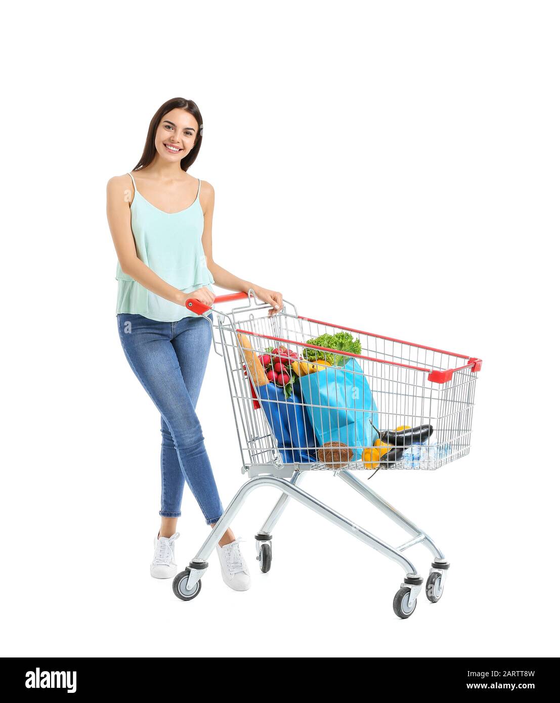 Young woman with shopping cart on white background Stock Photo - Alamy