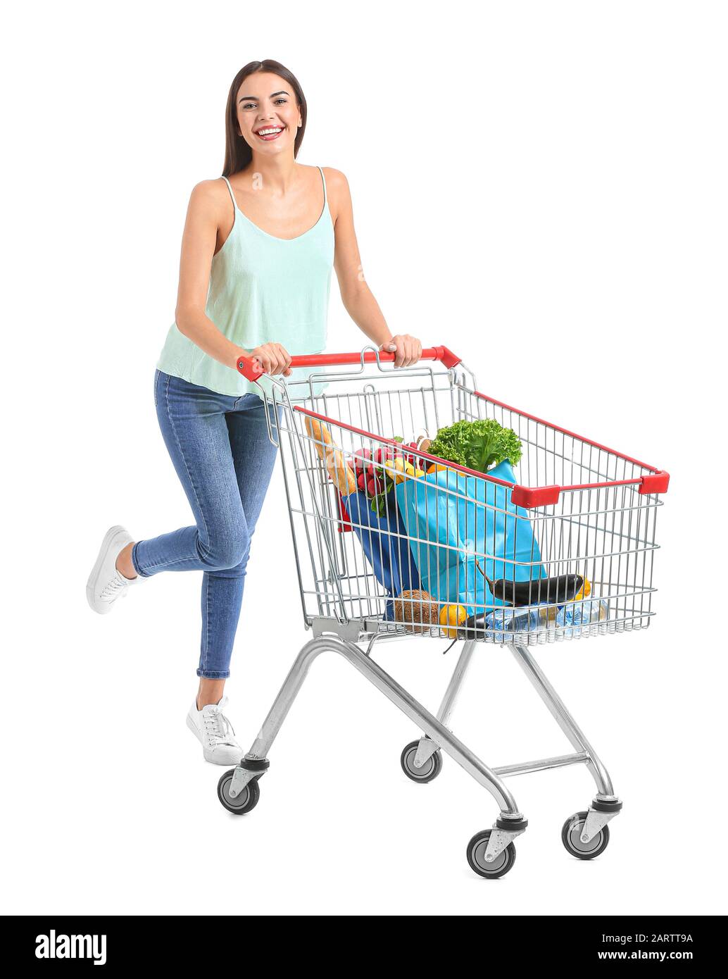 Young woman with shopping cart on white background Stock Photo - Alamy