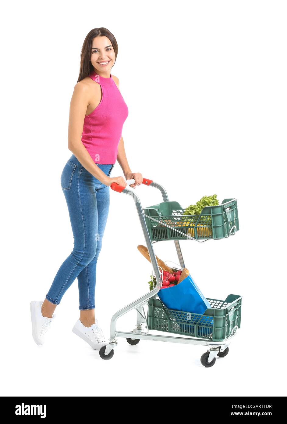Young woman with shopping cart on white background Stock Photo - Alamy
