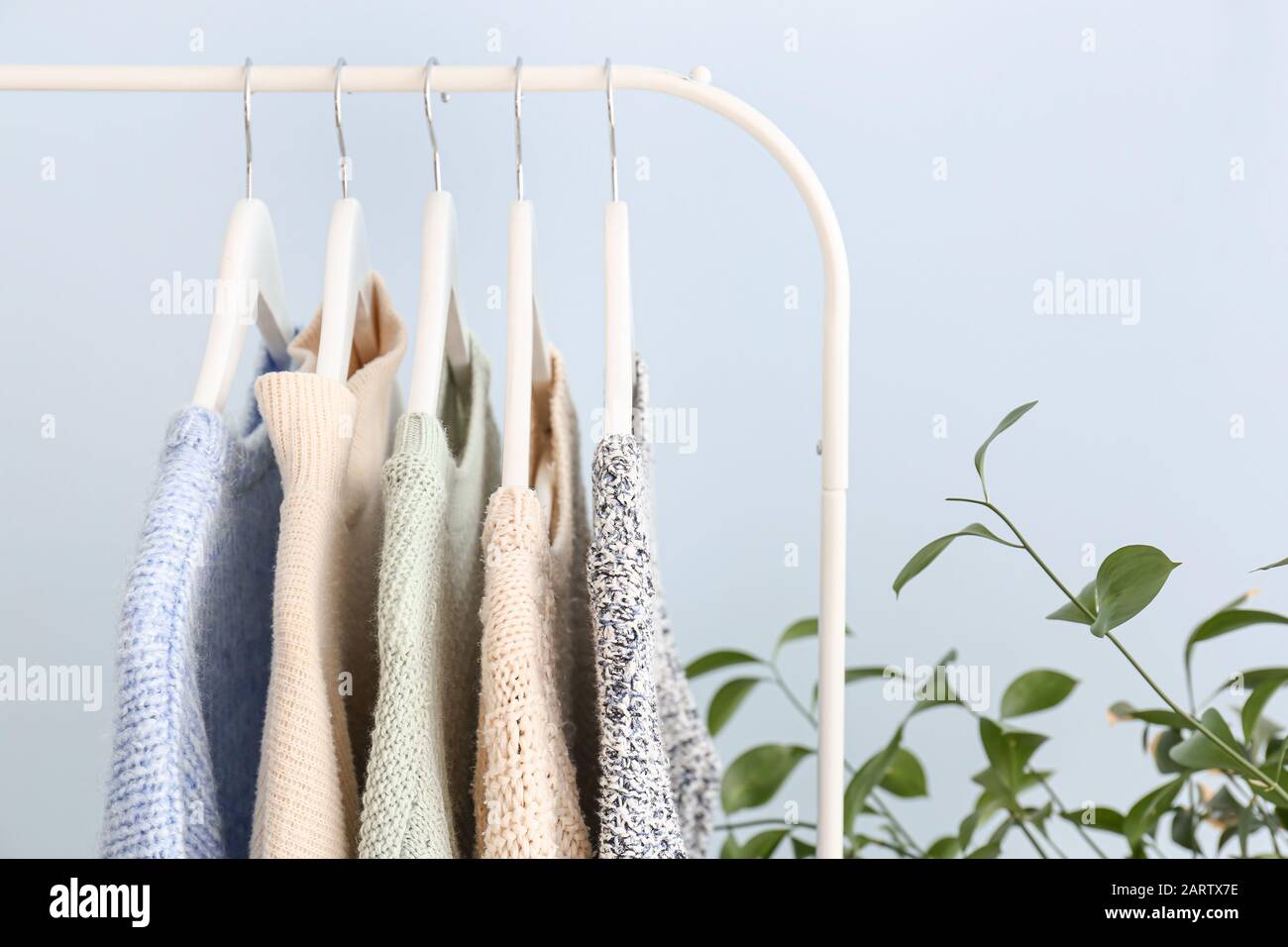Rack with winter clothes in dressing room Stock Photo - Alamy