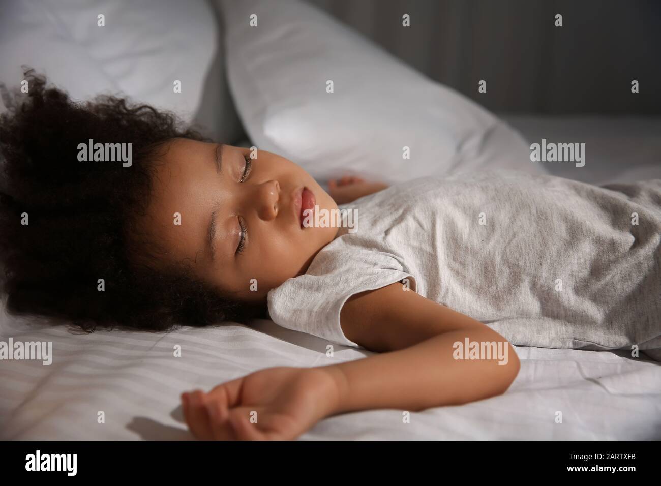 Little African-American girl sleeping in bed at night Stock Photo - Alamy