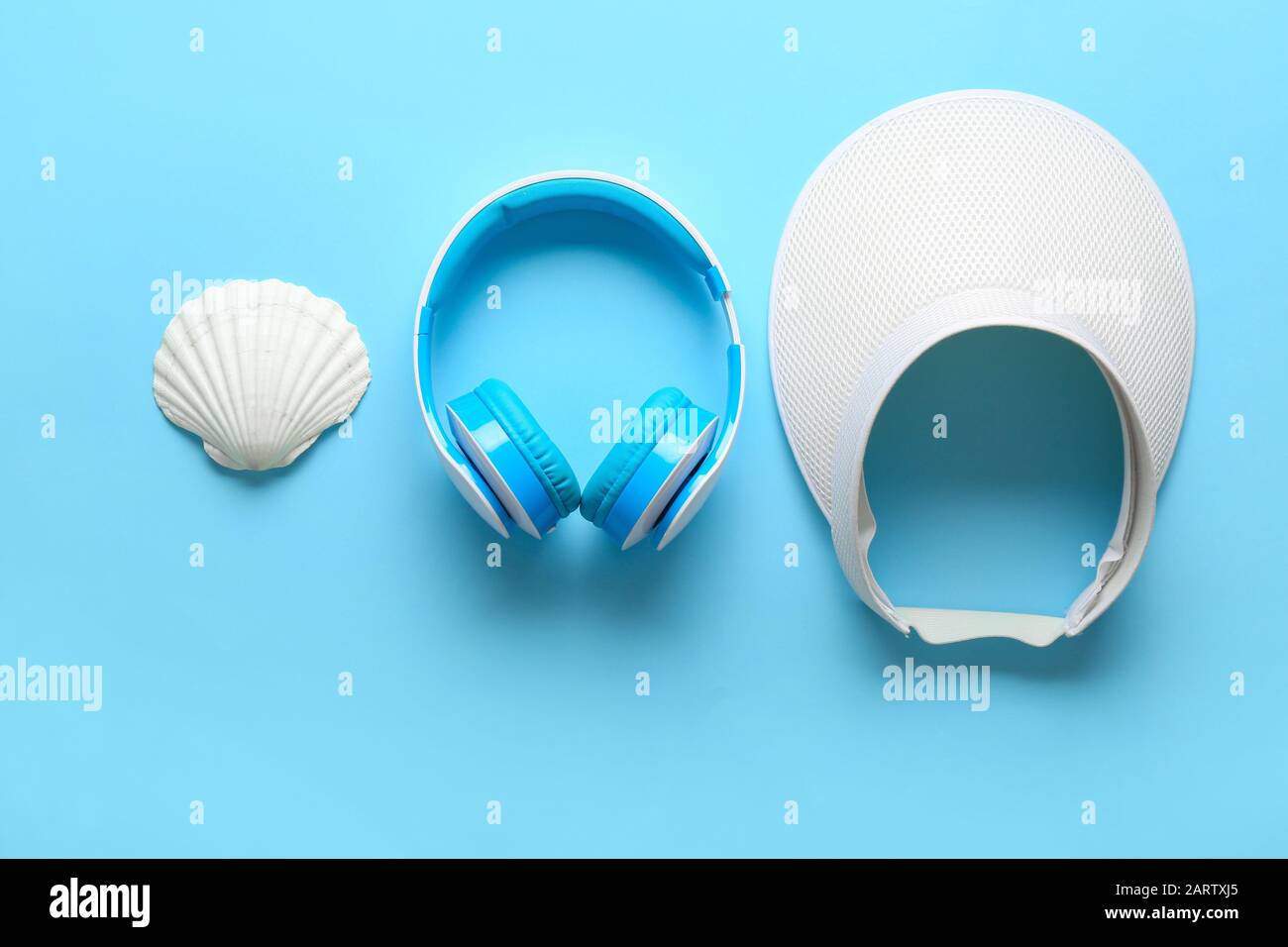 Sea shell, headphones and visor on color background Stock Photo - Alamy