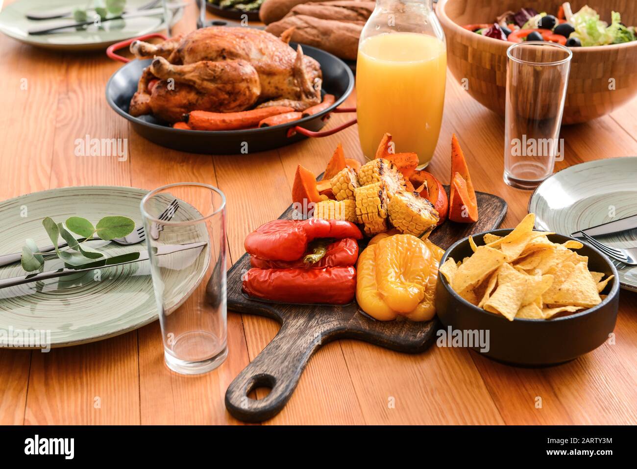 Table set for big family dinner Stock Photo - Alamy