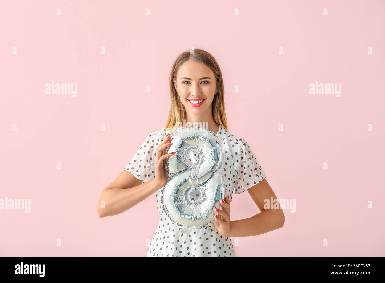 Beautiful young woman with figure 8 on color background. International ...