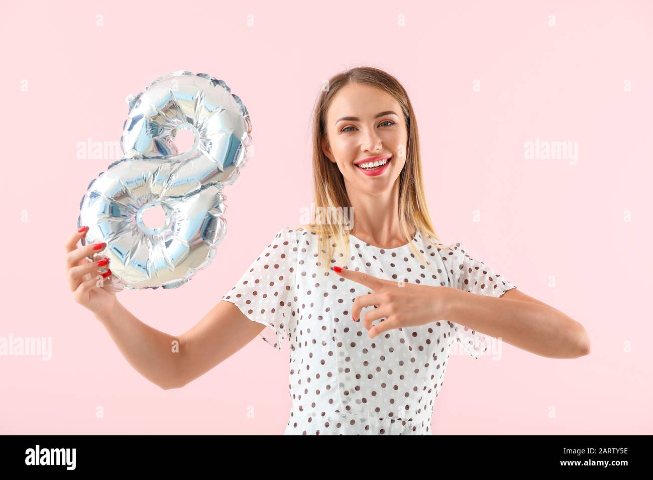 Beautiful young woman with figure 8 on color background. International ...