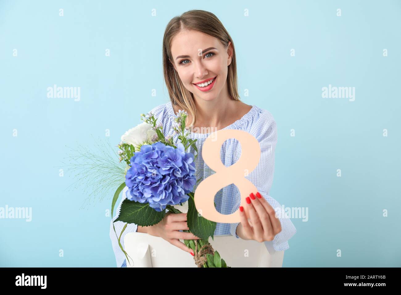 Beautiful young woman with figure 8 and flowers on color background ...