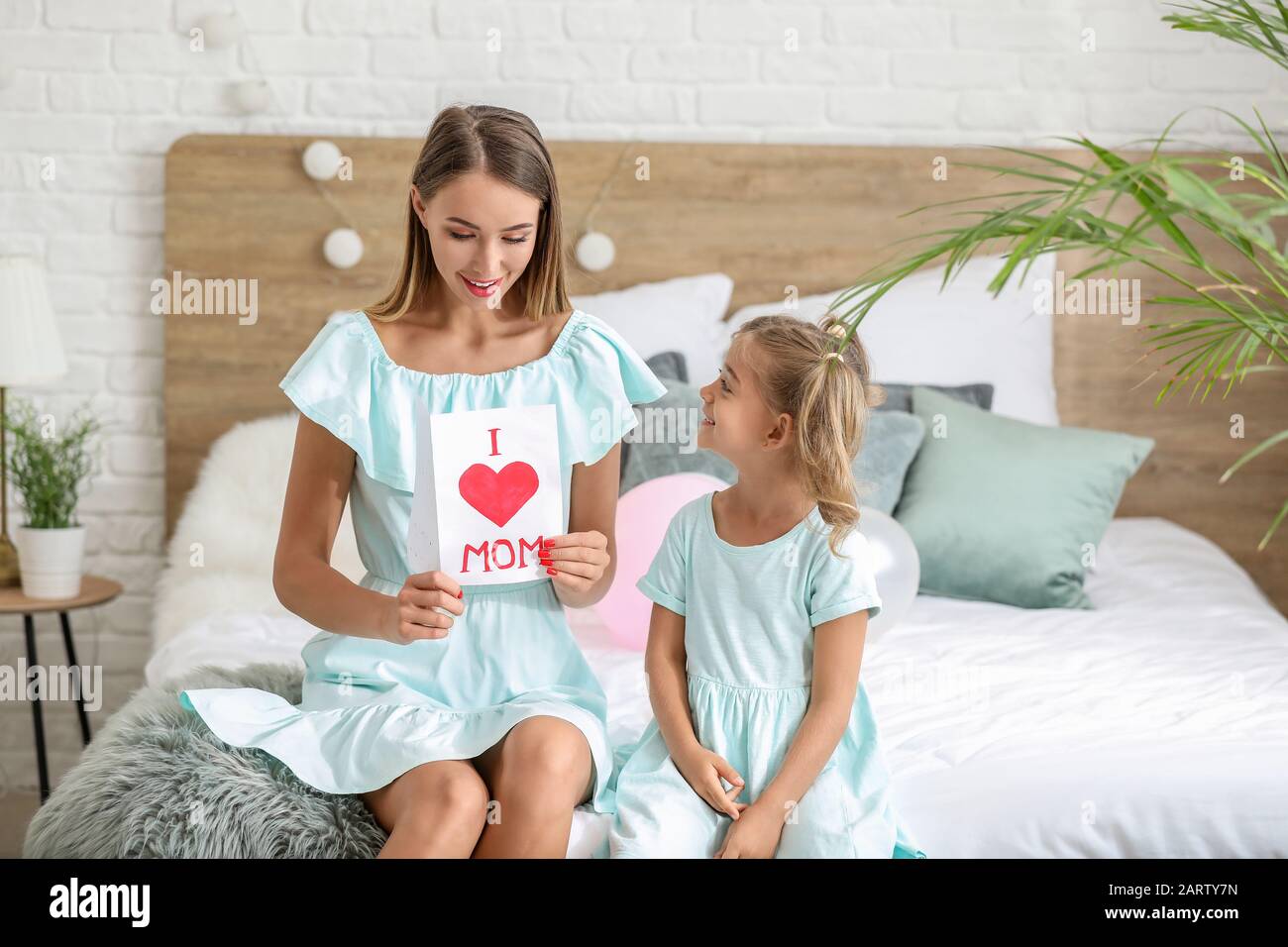 Little girl greeting her mother at home Stock Photo - Alamy
