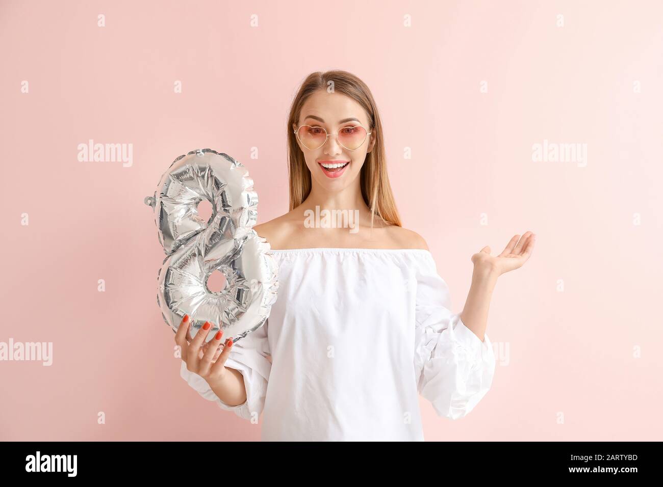 Beautiful young woman with figure 8 on color background. International ...