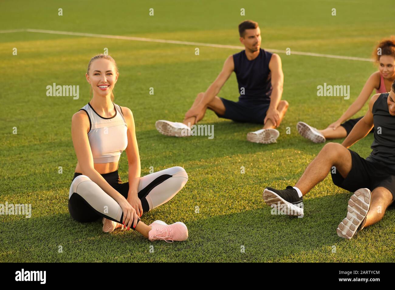 Group of sporty young people at the stadium Stock Photo - Alamy