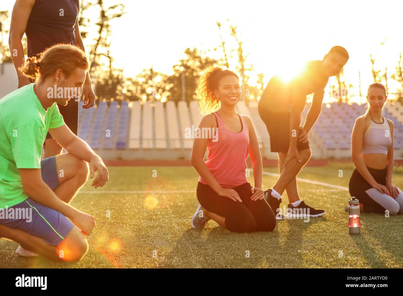 Group of sporty young people at the stadium Stock Photo - Alamy