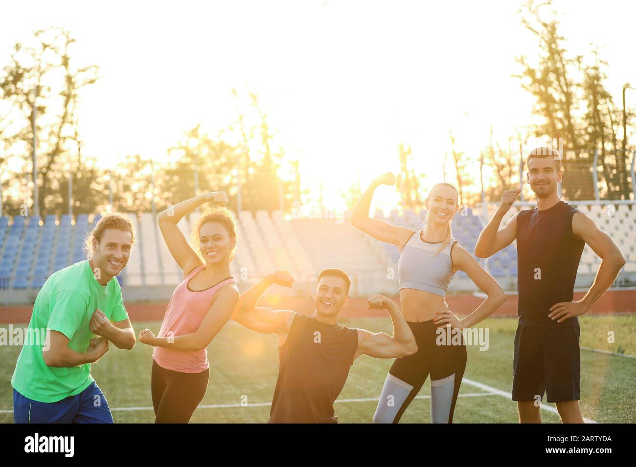 Group of sporty young people at the stadium Stock Photo - Alamy