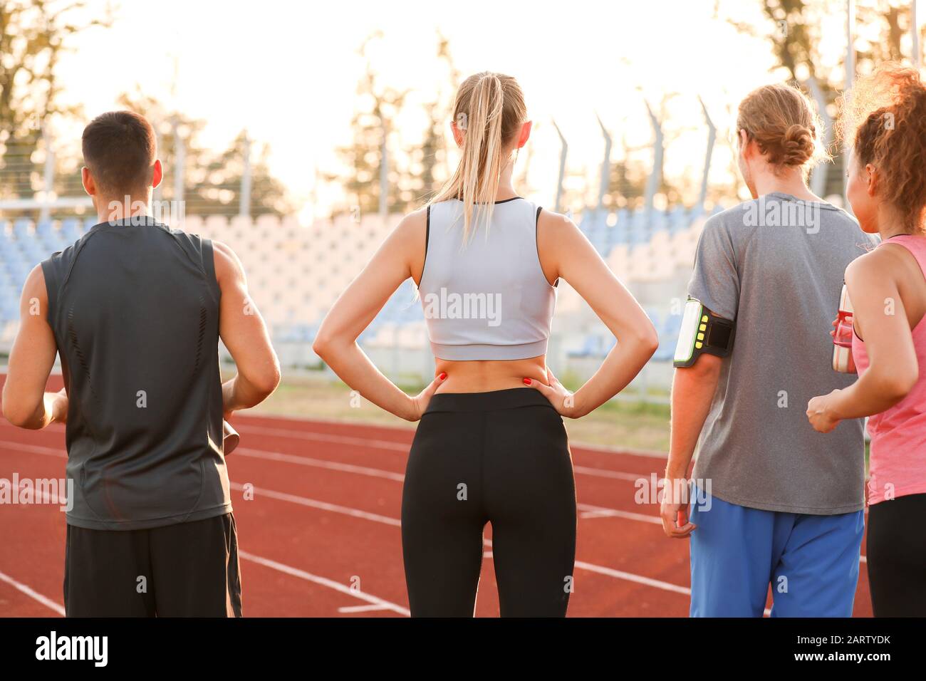Group of sporty young people at the stadium Stock Photo - Alamy