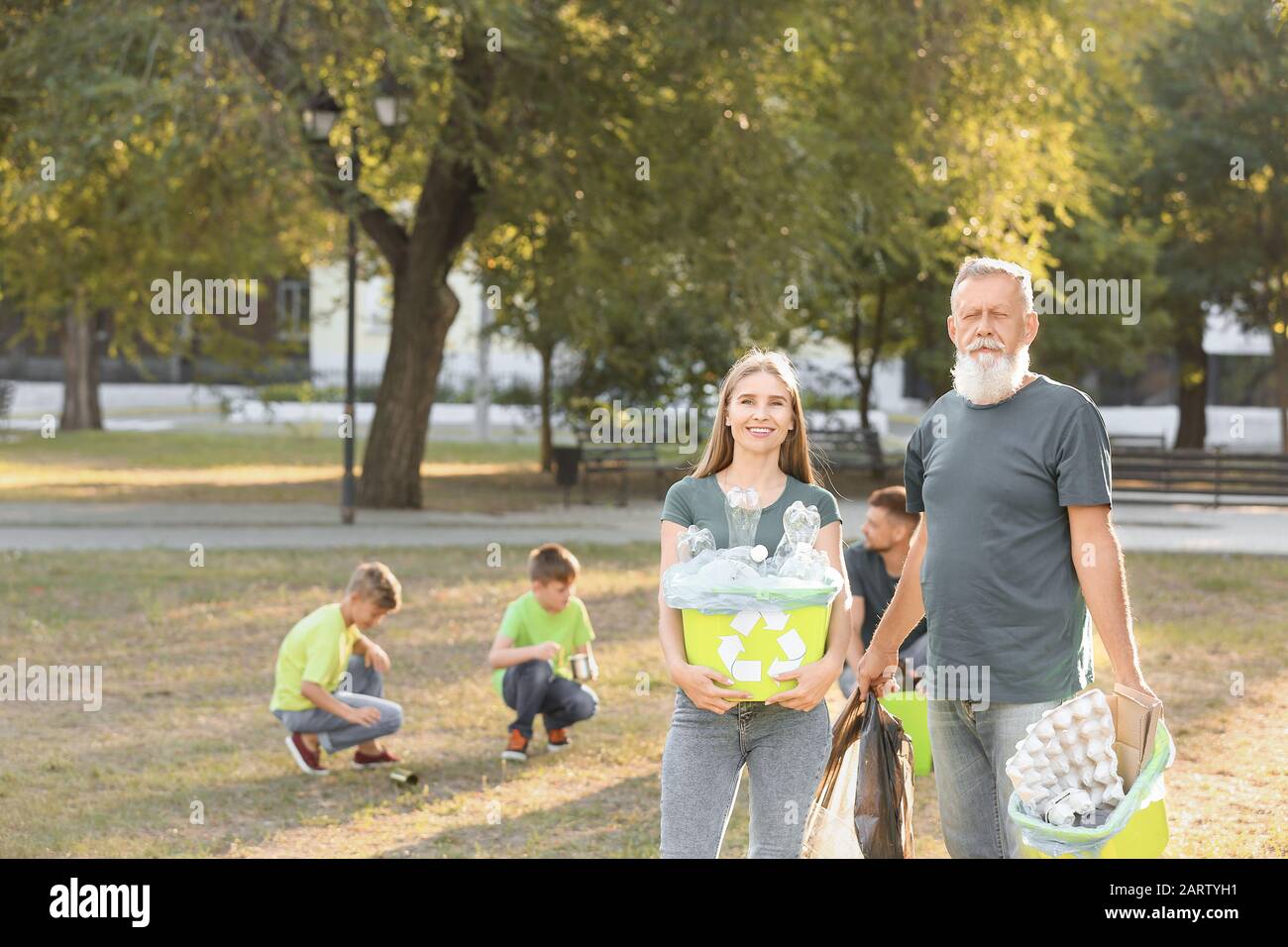 People gathering garbage outdoors. Concept of recycling Stock Photo - Alamy