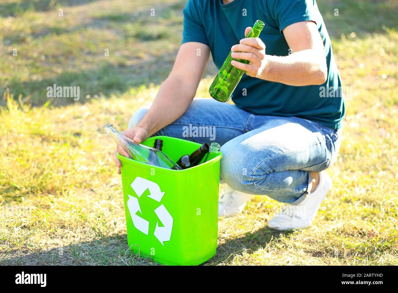Man gathering garbage outdoors. Concept of recycling Stock Photo - Alamy