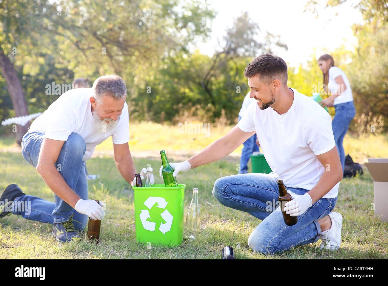People gathering garbage outdoors. Concept of recycling Stock Photo - Alamy