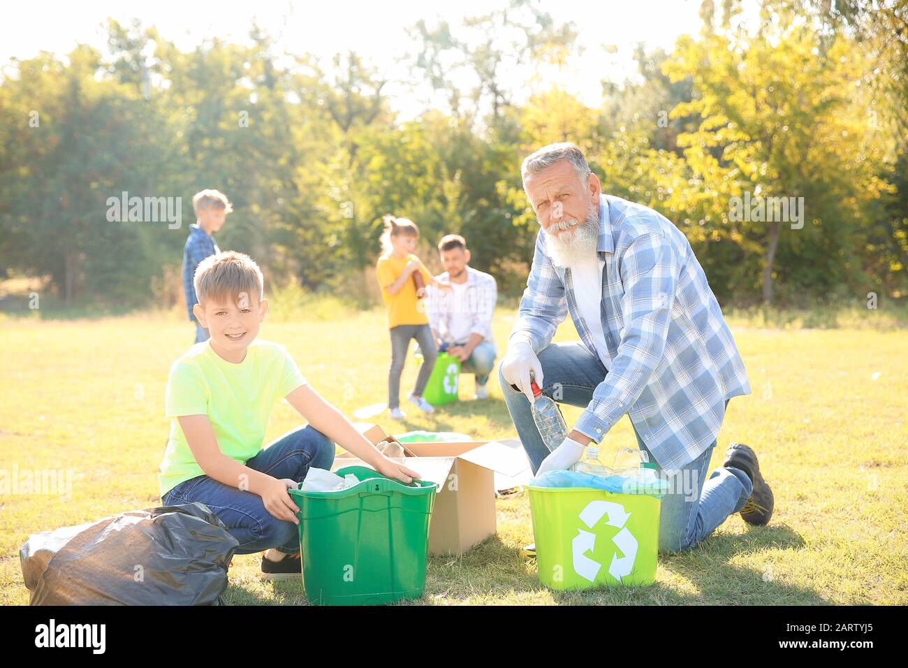 People gathering garbage outdoors. Concept of recycling Stock Photo - Alamy