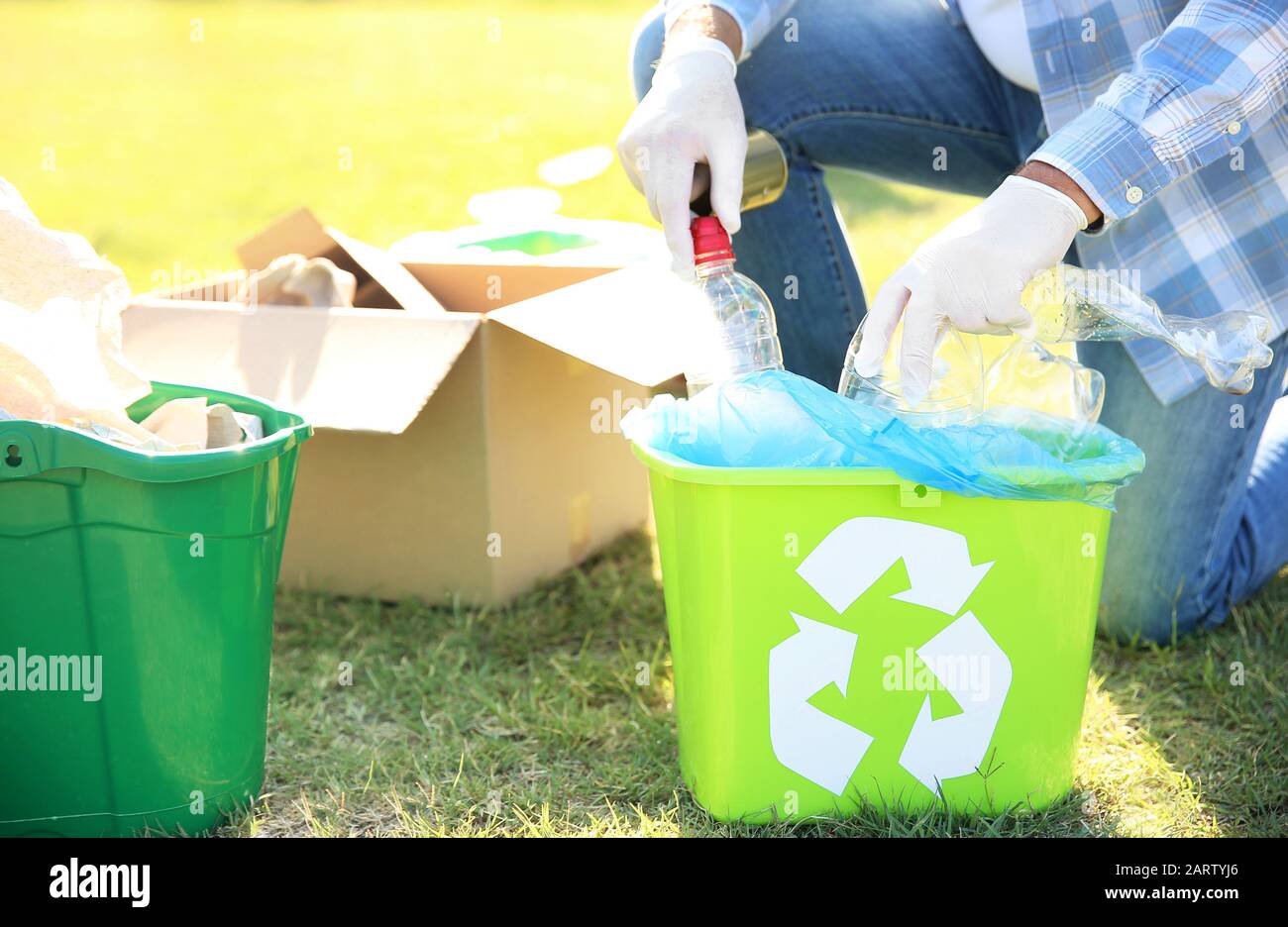 Man gathering garbage outdoors. Concept of recycling Stock Photo - Alamy