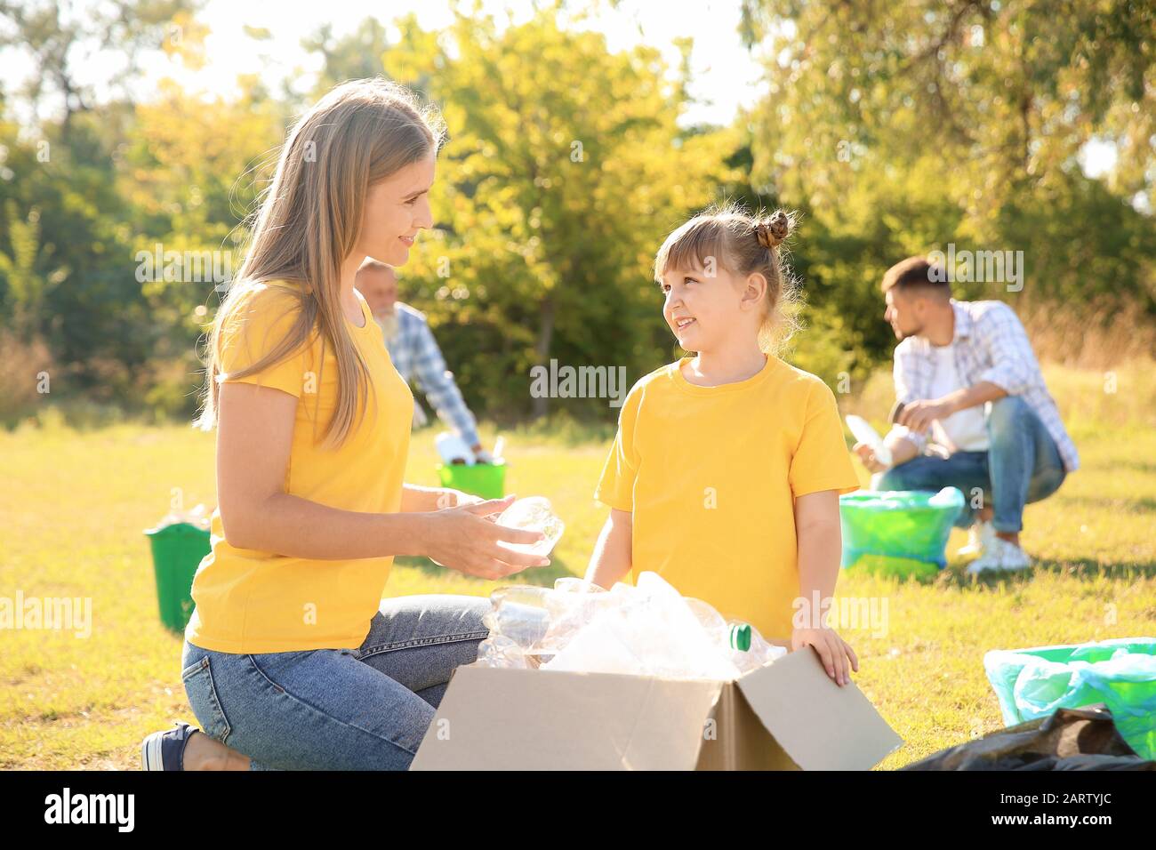 People gathering garbage outdoors. Concept of recycling Stock Photo - Alamy