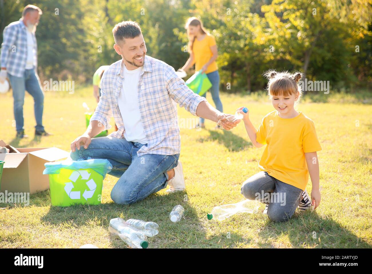 People gathering garbage outdoors. Concept of recycling Stock Photo - Alamy