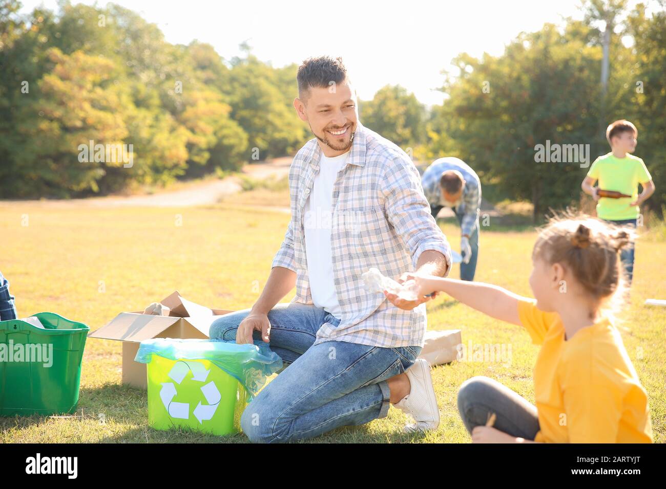 People gathering garbage outdoors. Concept of recycling Stock Photo - Alamy