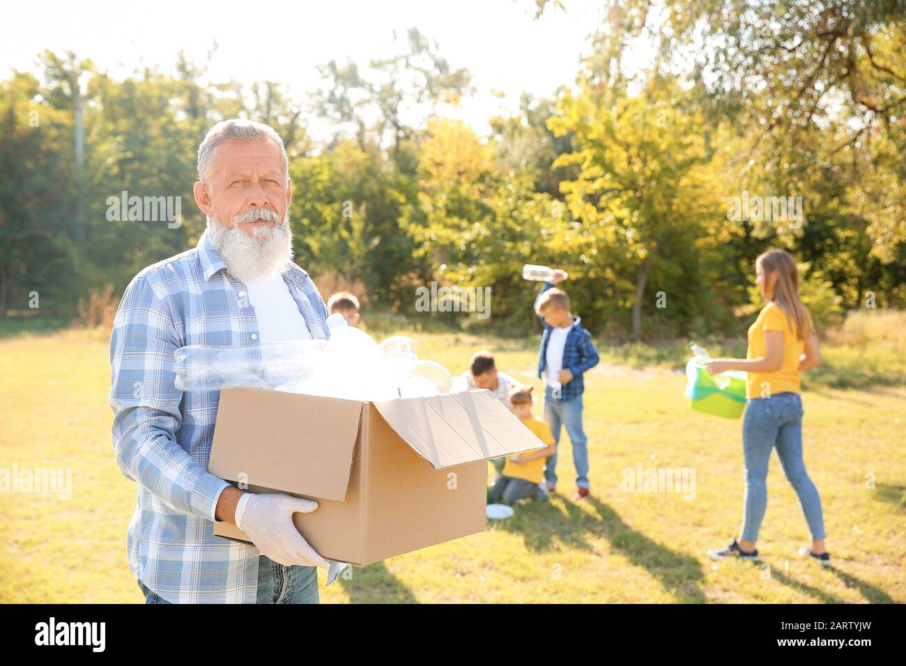 People gathering garbage outdoors. Concept of recycling Stock Photo - Alamy