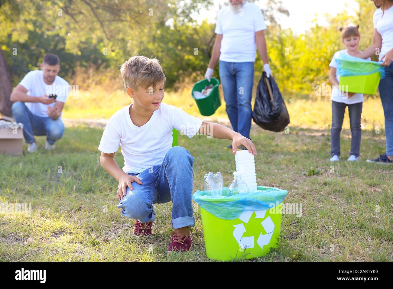 People gathering garbage outdoors. Concept of recycling Stock Photo - Alamy