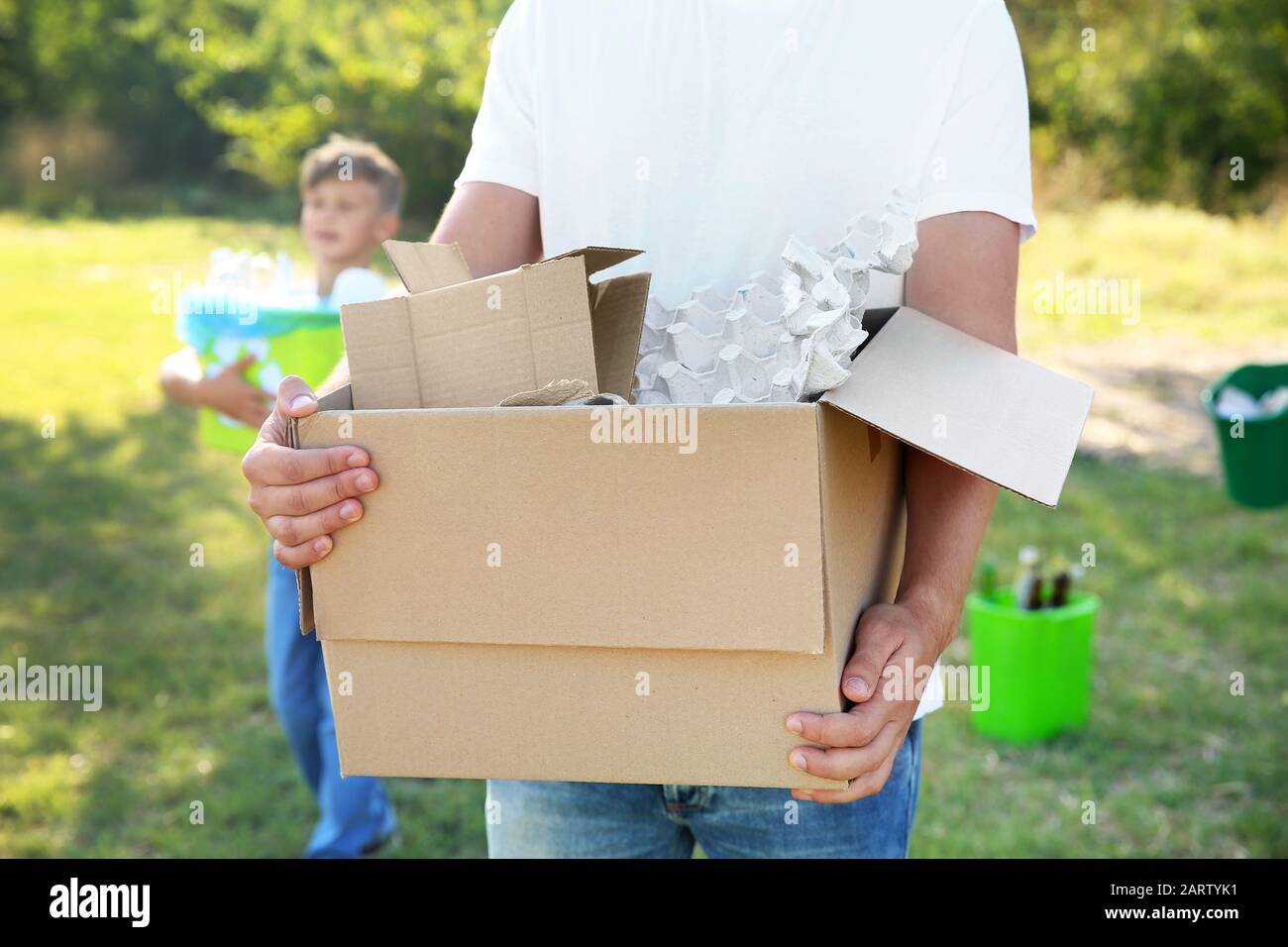 Man with gathered garbage outdoors. Concept of recycling Stock Photo ...