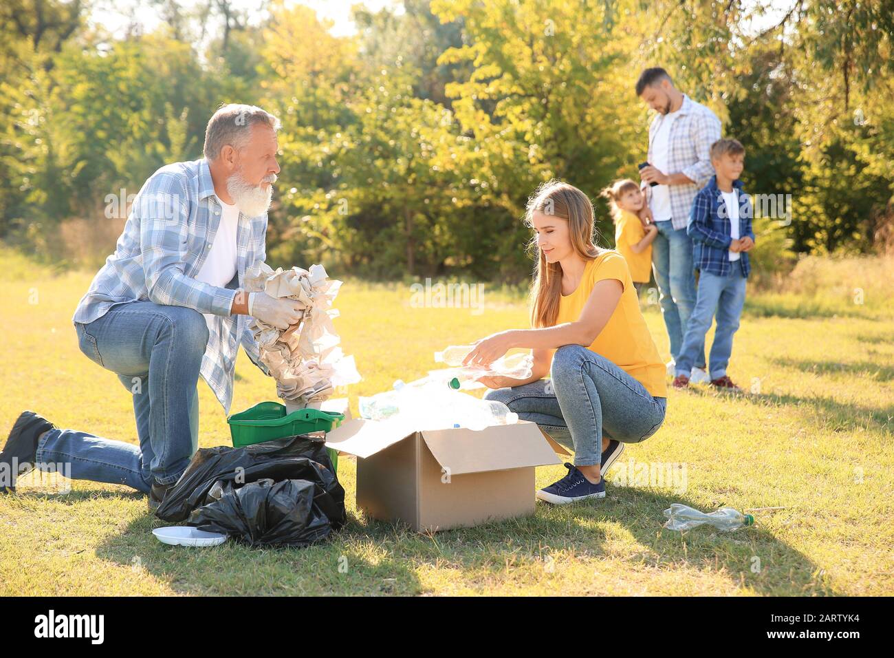 People gathering garbage outdoors. Concept of recycling Stock Photo - Alamy