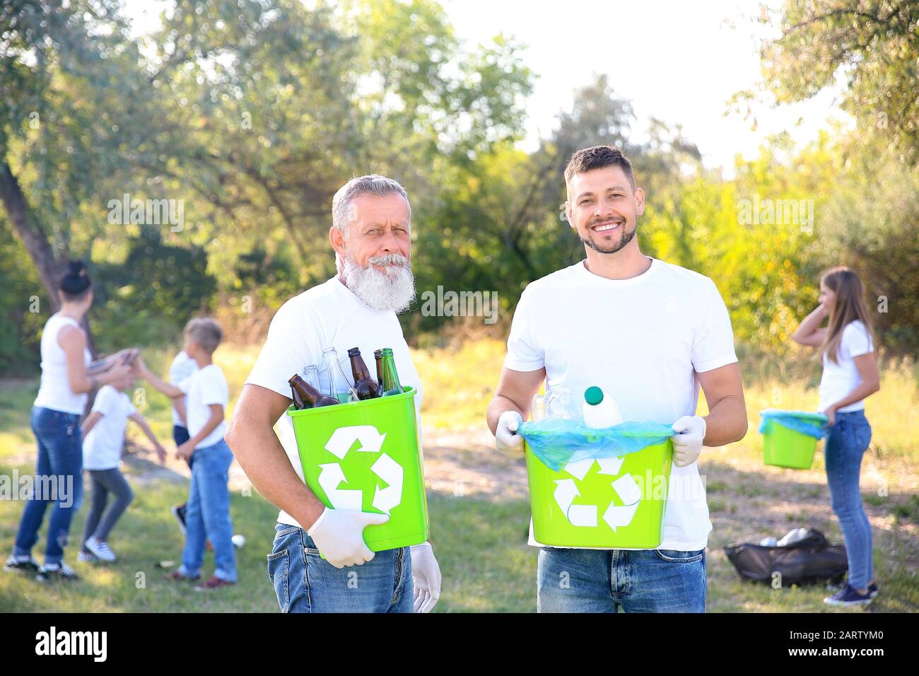 Men with gathered garbage outdoors. Concept of recycling Stock Photo ...