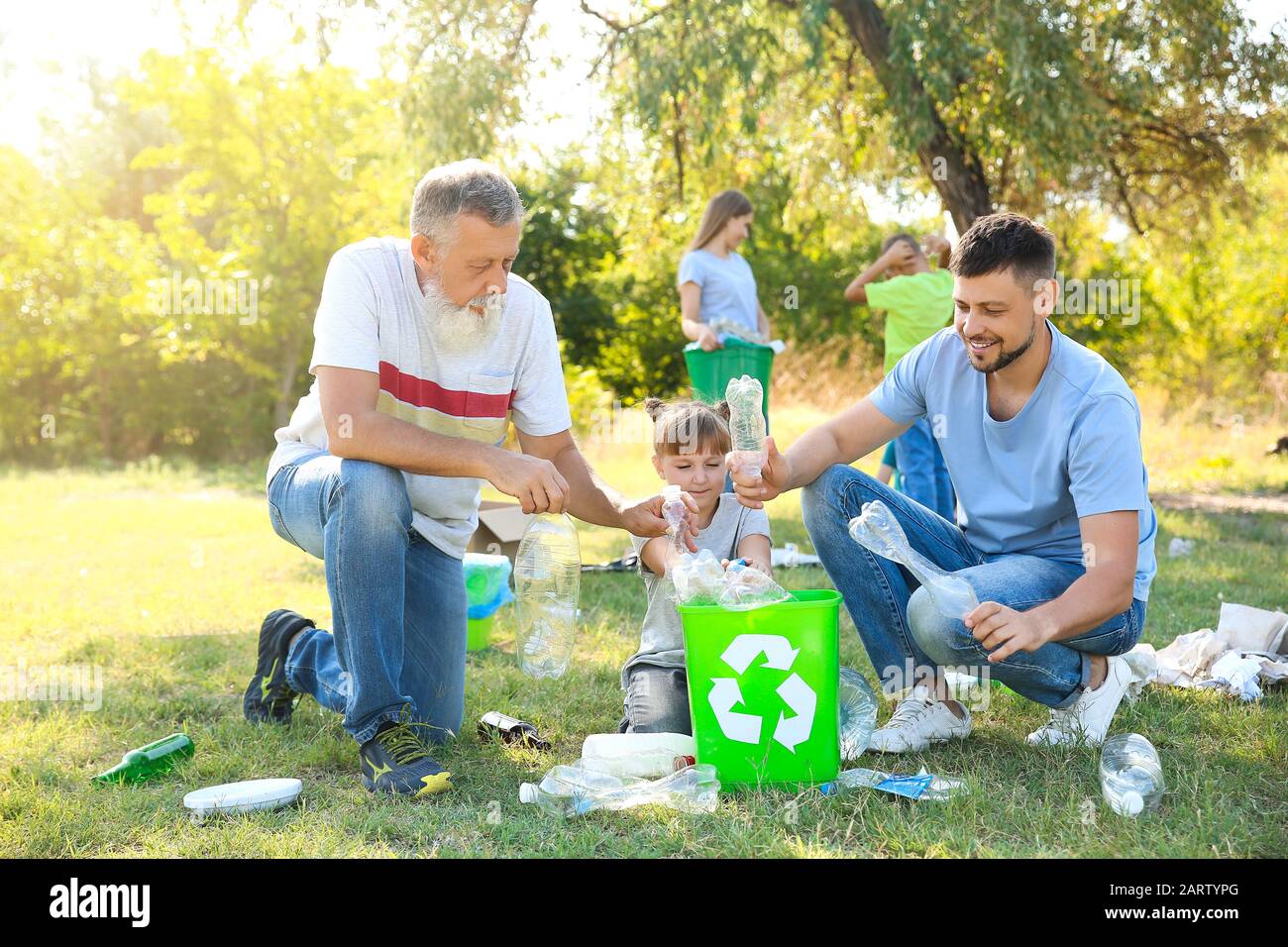 People gathering garbage outdoors. Concept of recycling Stock Photo - Alamy
