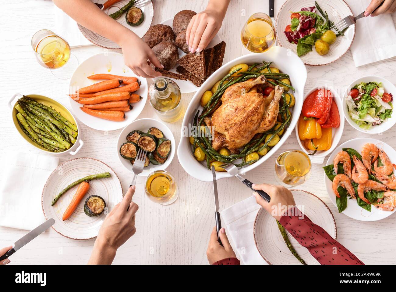 Friends having dinner at table, top view Stock Photo - Alamy