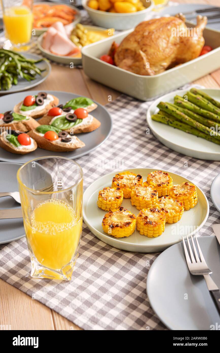 Many dishes served on table for big family dinner Stock Photo - Alamy