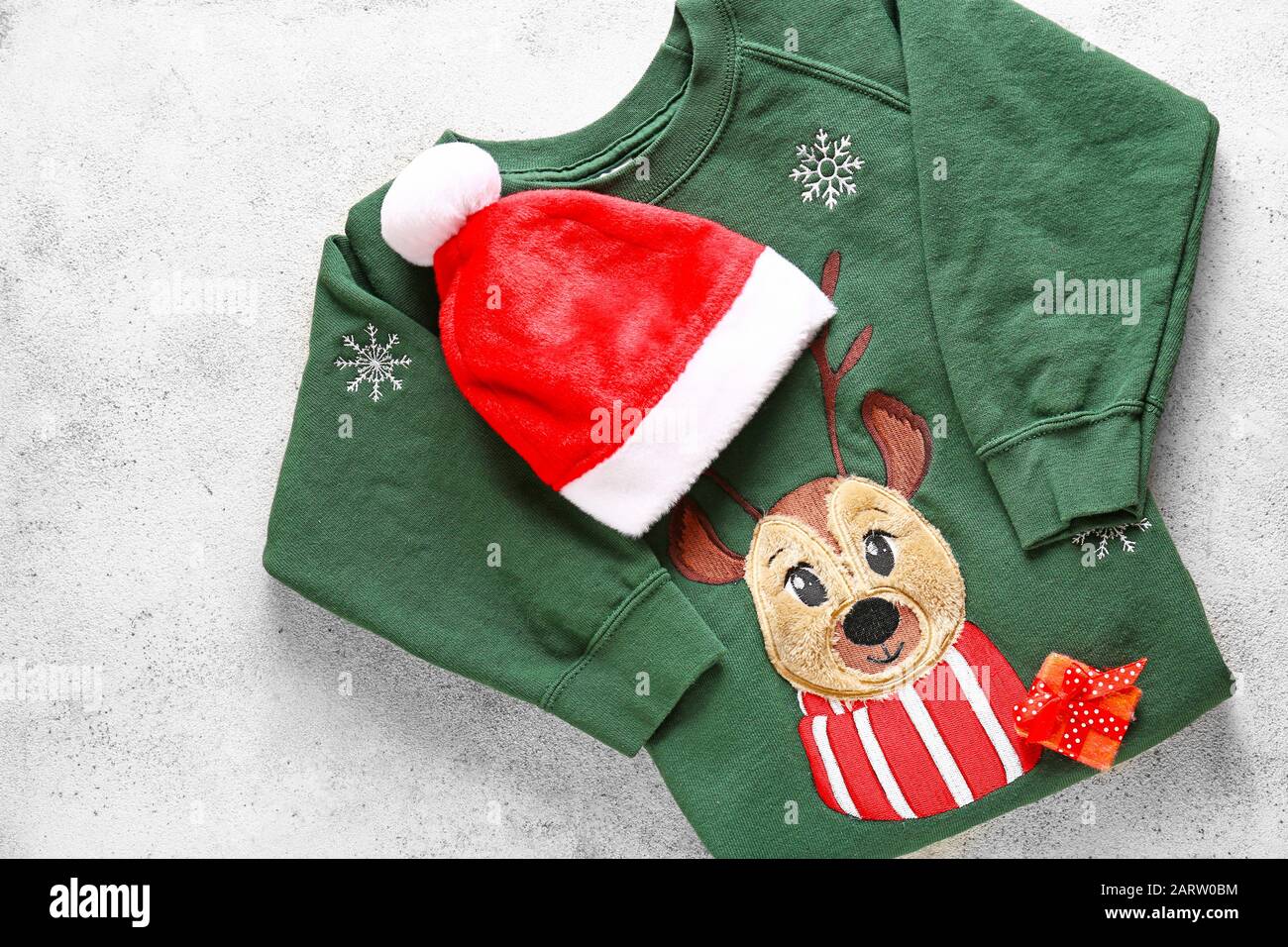 Set of Christmas clothes on light background Stock Photo - Alamy