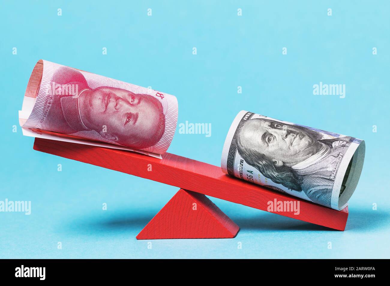 Dollars and yuan on a swing. Strong currency concept Stock Photo - Alamy