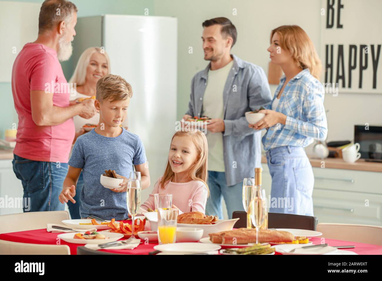 Big family serving table for dinner at home Stock Photo - Alamy