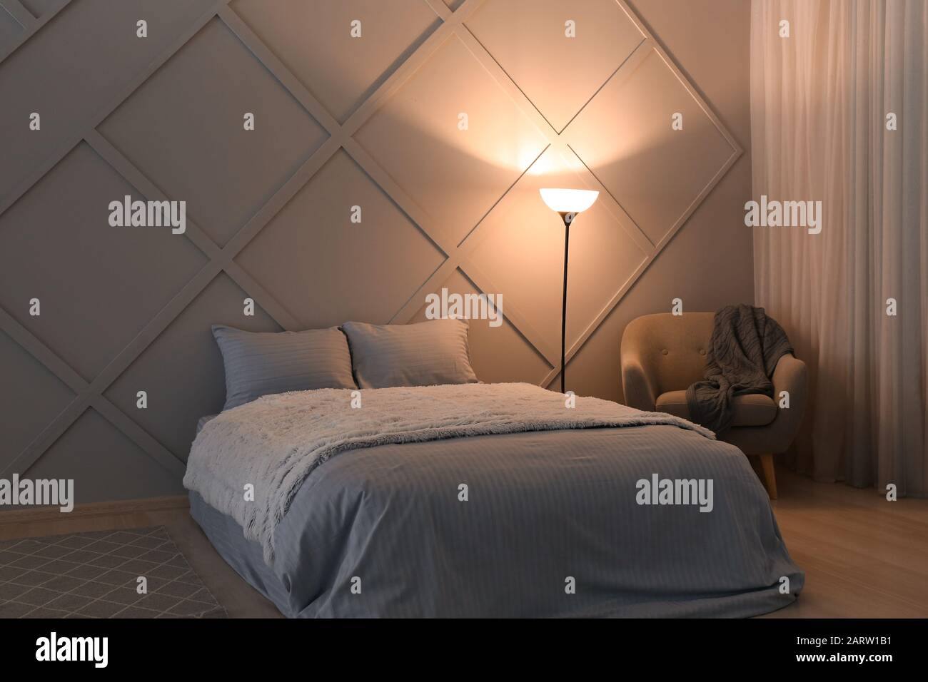 Stylish interior of bedroom at night Stock Photo - Alamy